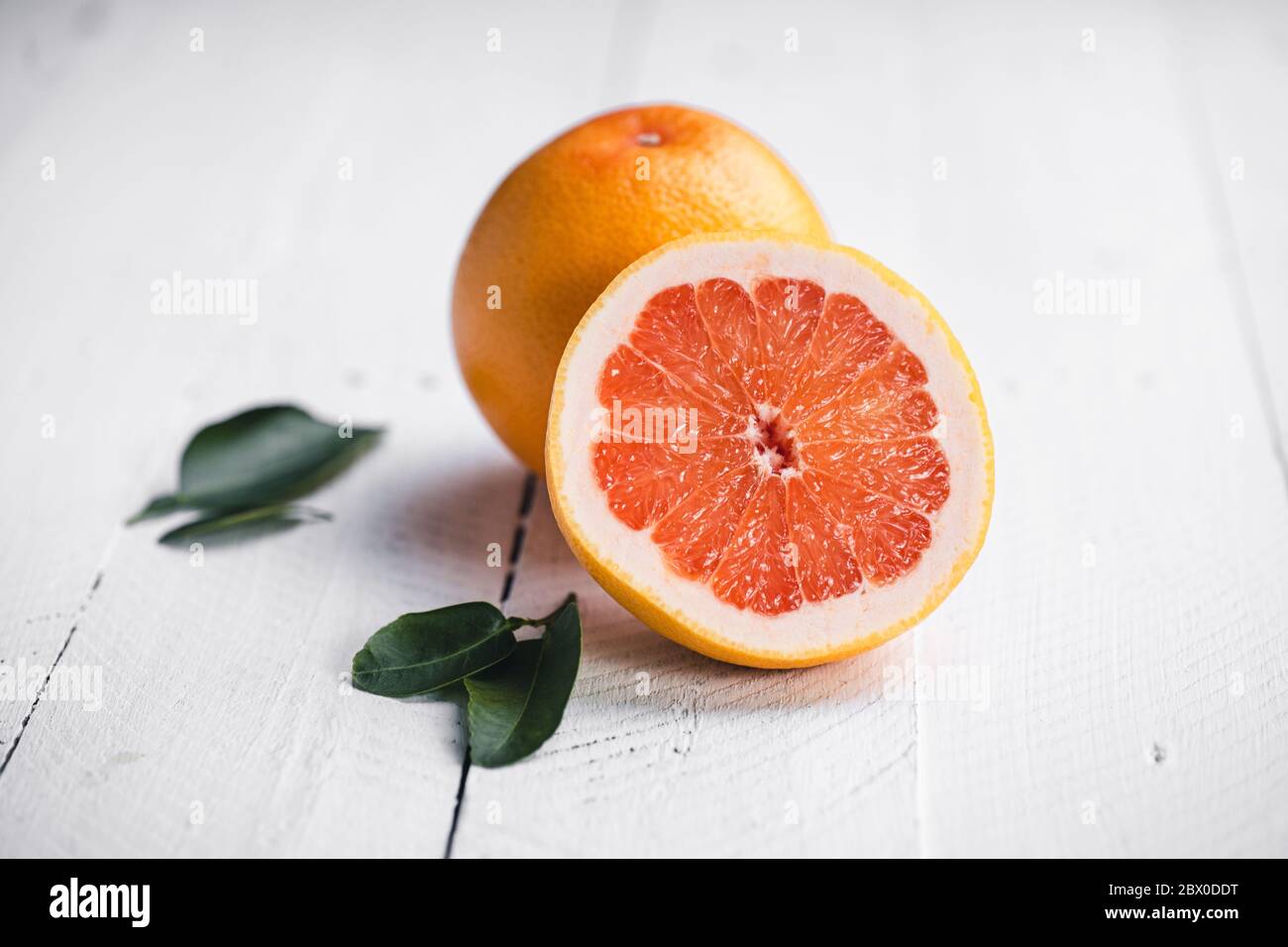 Grapefruit on the white wood background In the studio Stock Photo - Alamy