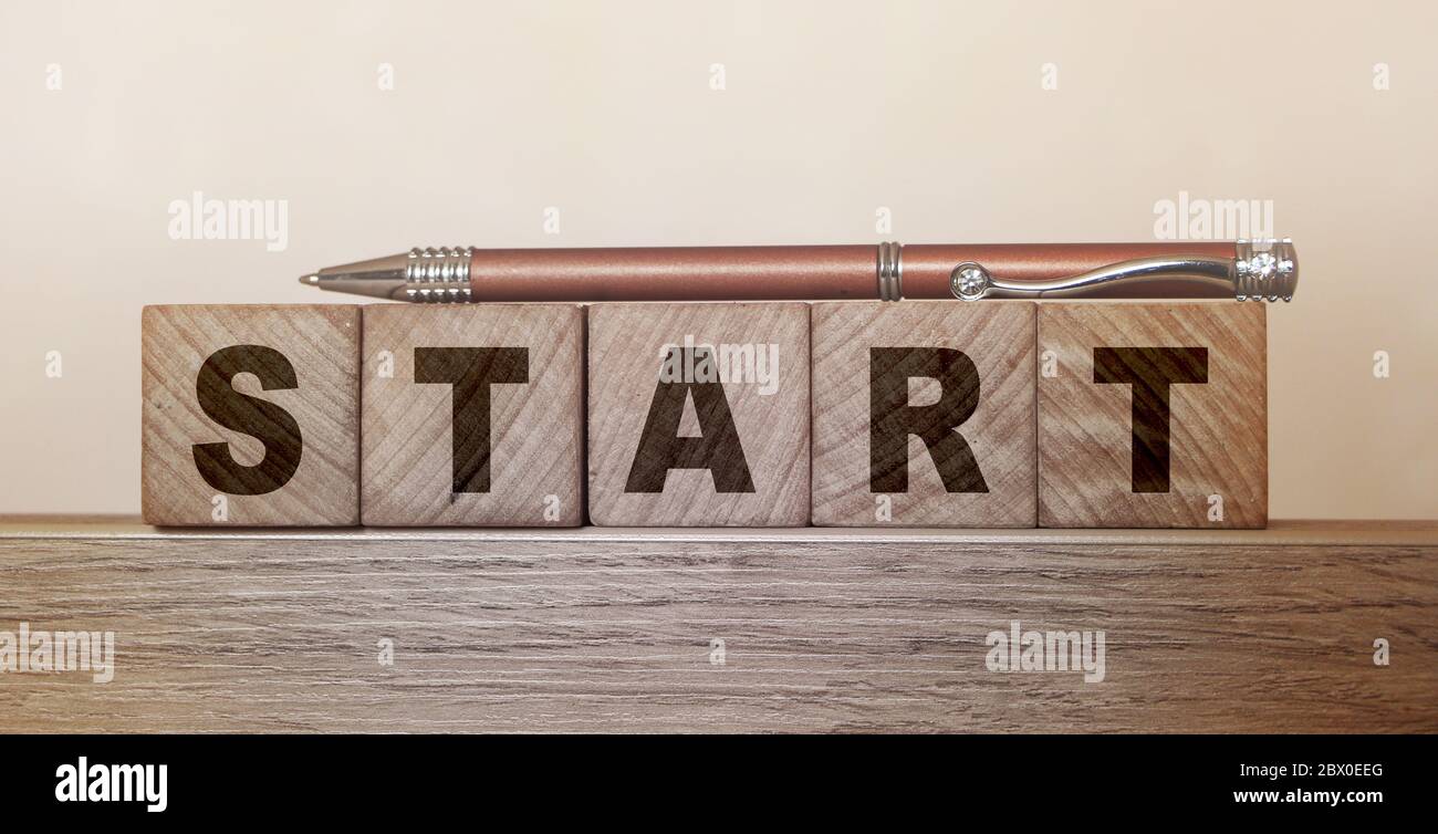 Concept word formed with cubes on wooden desk background - Start ...