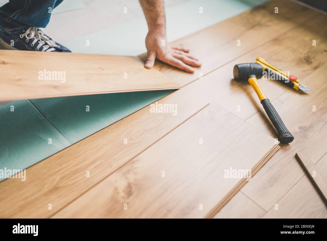 Professional flooring installation - laying a new laminate with a ...