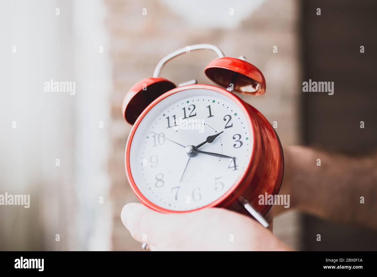 Early rise to work - a big red alarm clock Stock Photo - Alamy