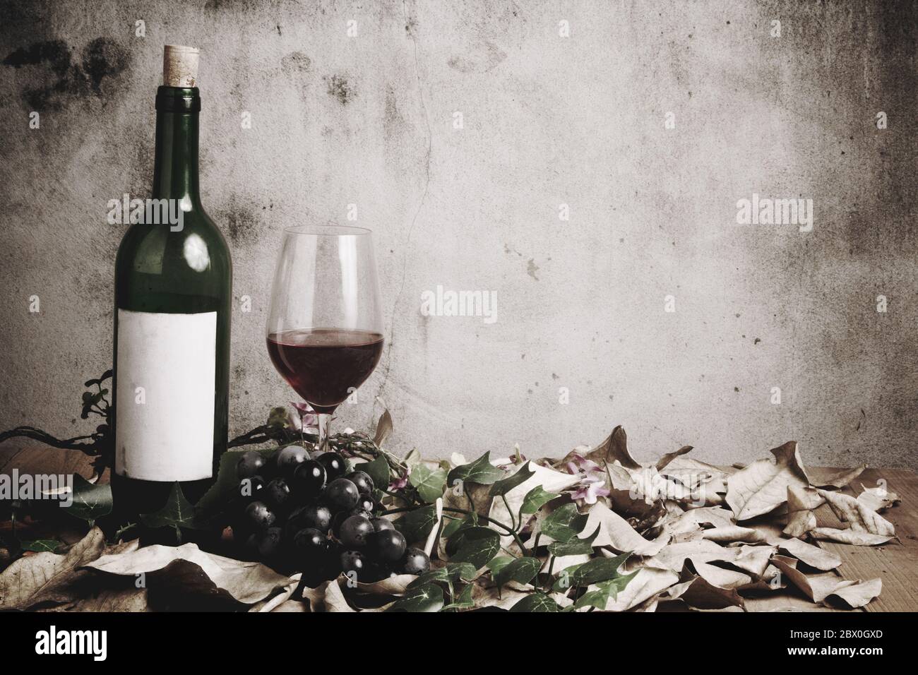 Still life of red wine bottle and wine glass Stock Photo - Alamy