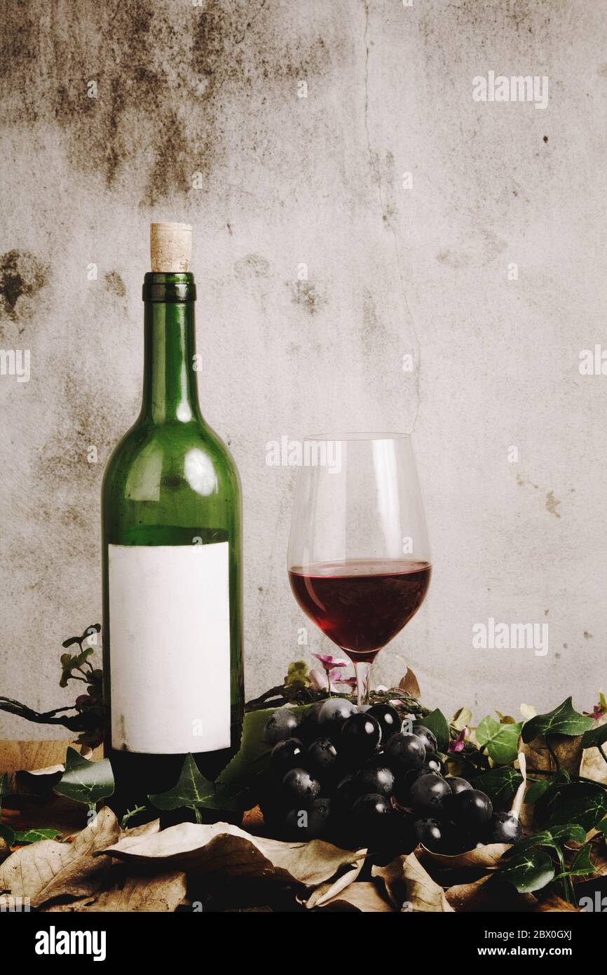 Still life of red wine bottle and wine glass Stock Photo - Alamy