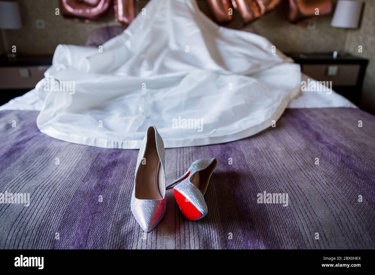 wedding dress on the bed in morning Stock Photo - Alamy