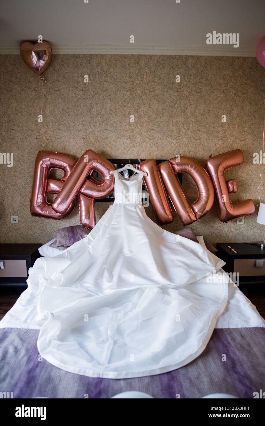 wedding dress on the bed in morning Stock Photo - Alamy