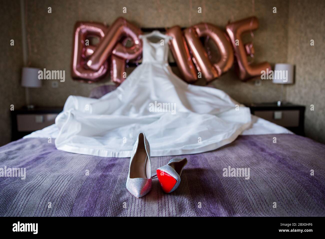 wedding dress on the bed in morning Stock Photo - Alamy