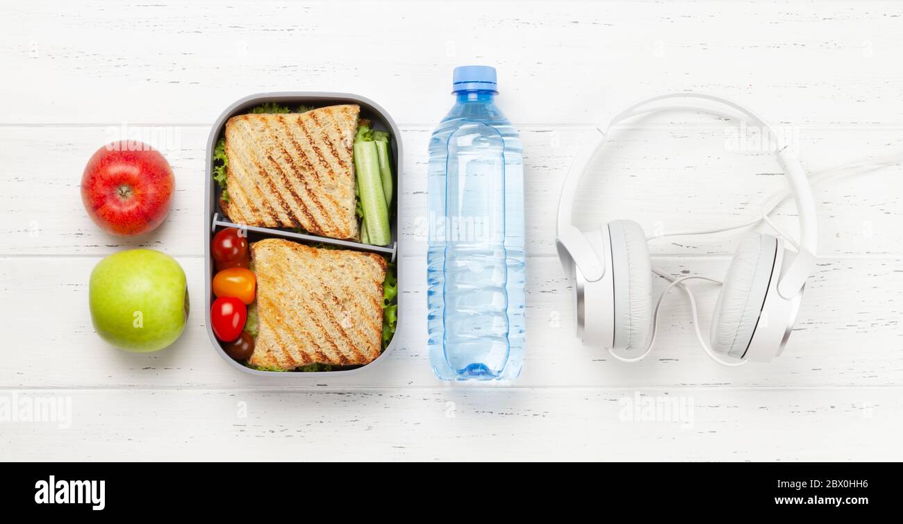 Healthy lunch box with sandwich and vegetables on wooden table. Top ...