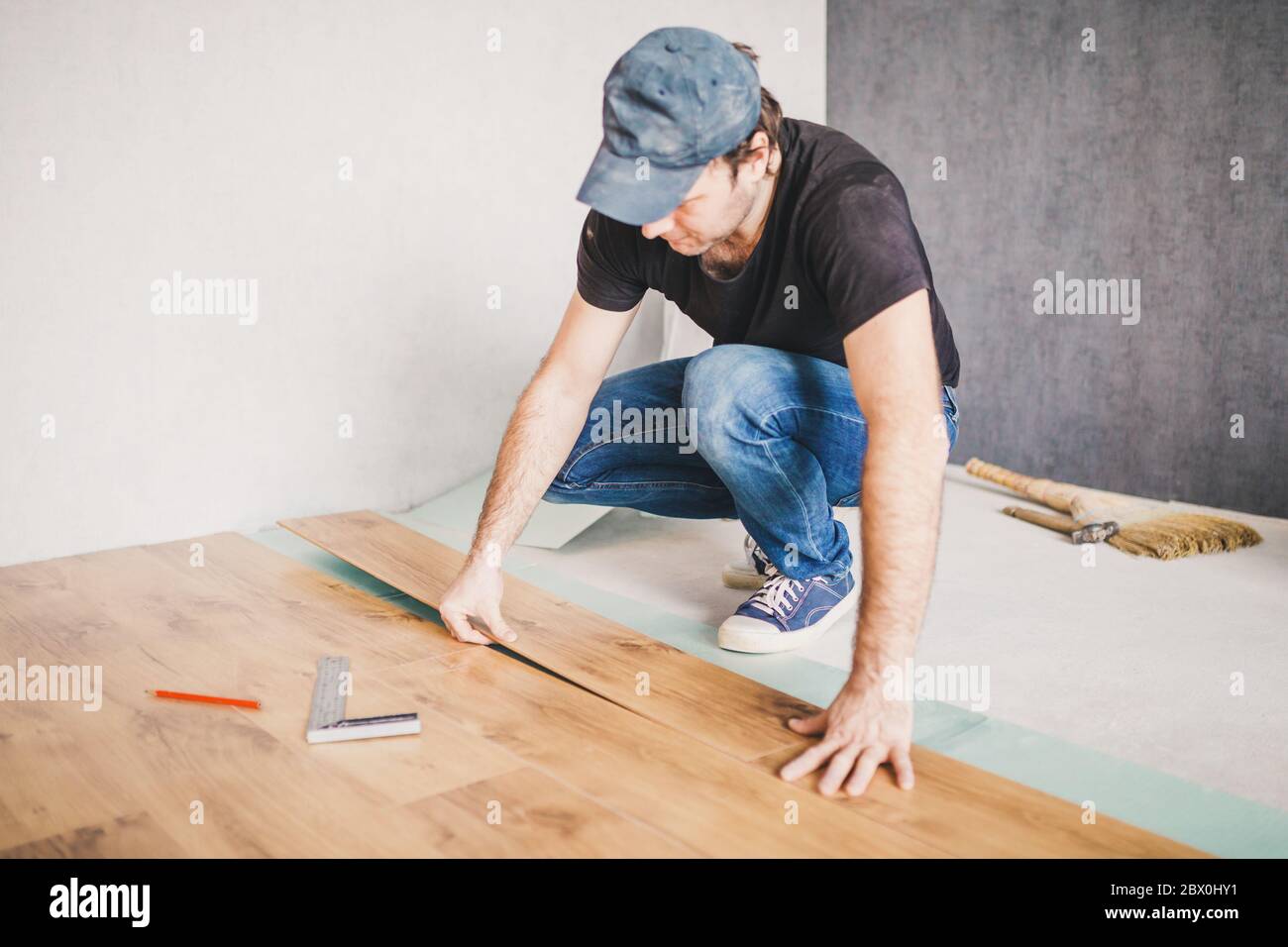 Man laying flooring home hi-res stock photography and images - Alamy