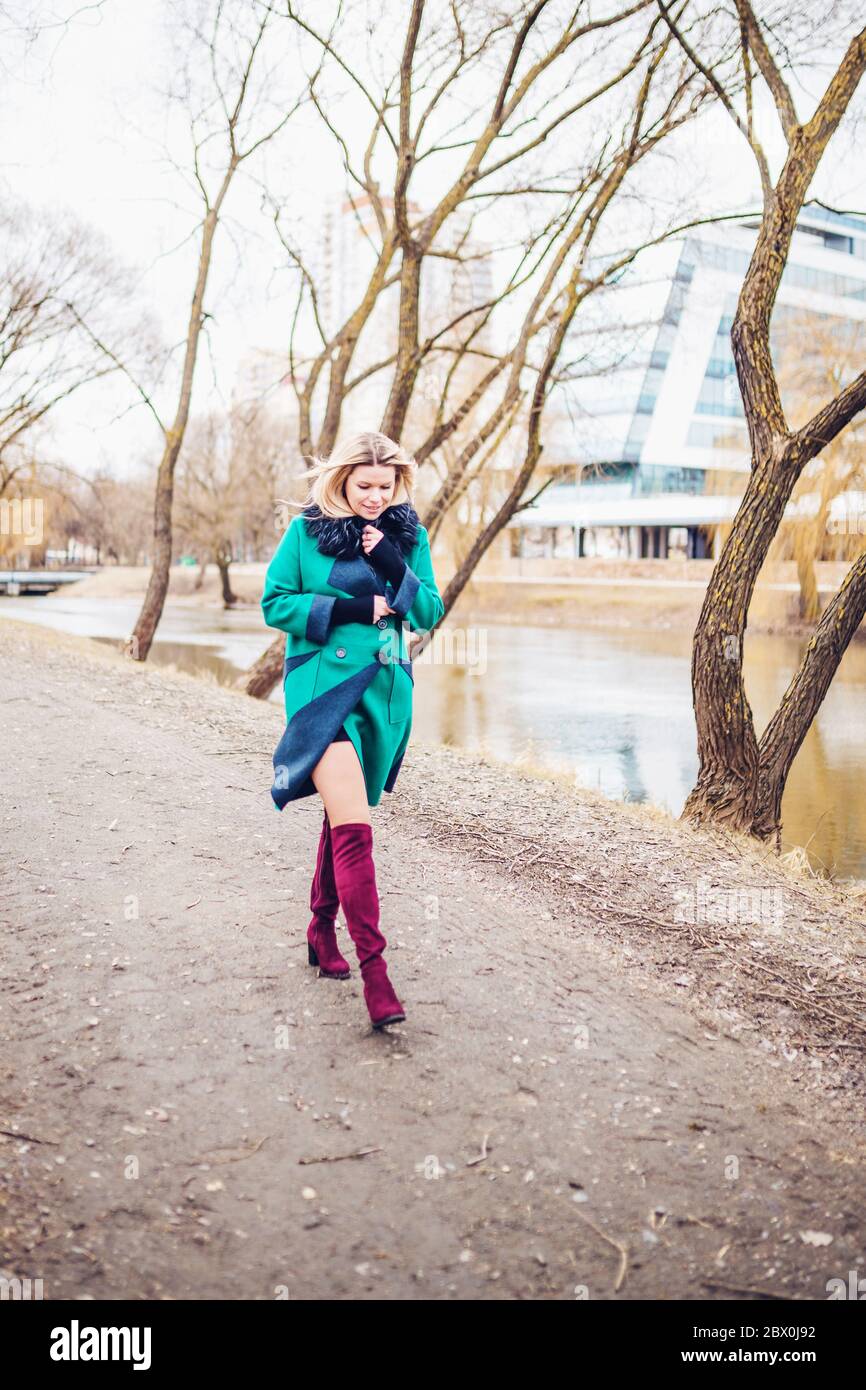 Beautiful blonde fashionable scandinavian woman walks in the park in ...
