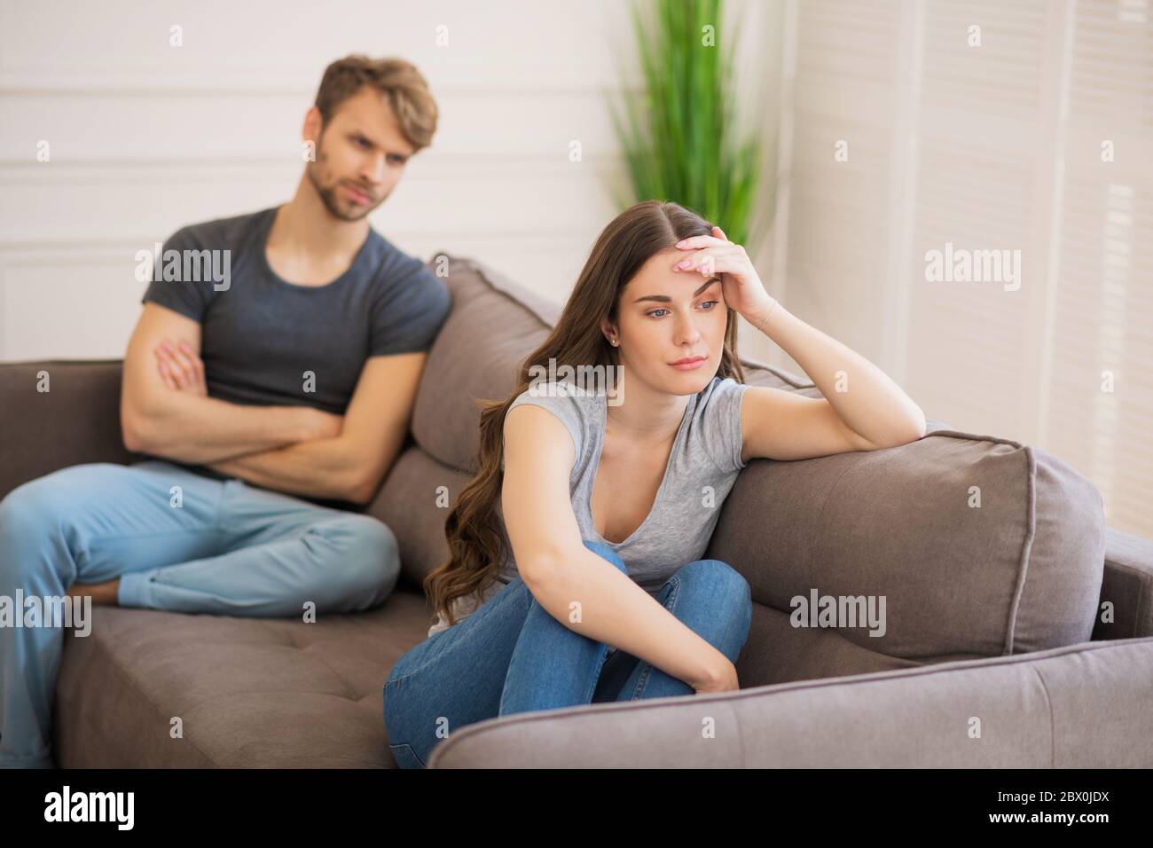 Young woman sit looking offended after a bad talk with her husband ...