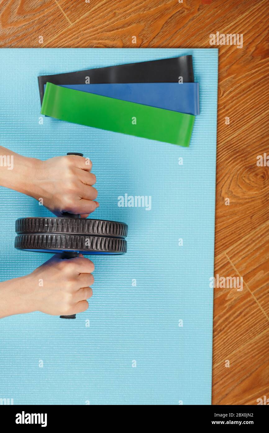 Sports blue roll for training the abs in the hands Stock Photo - Alamy