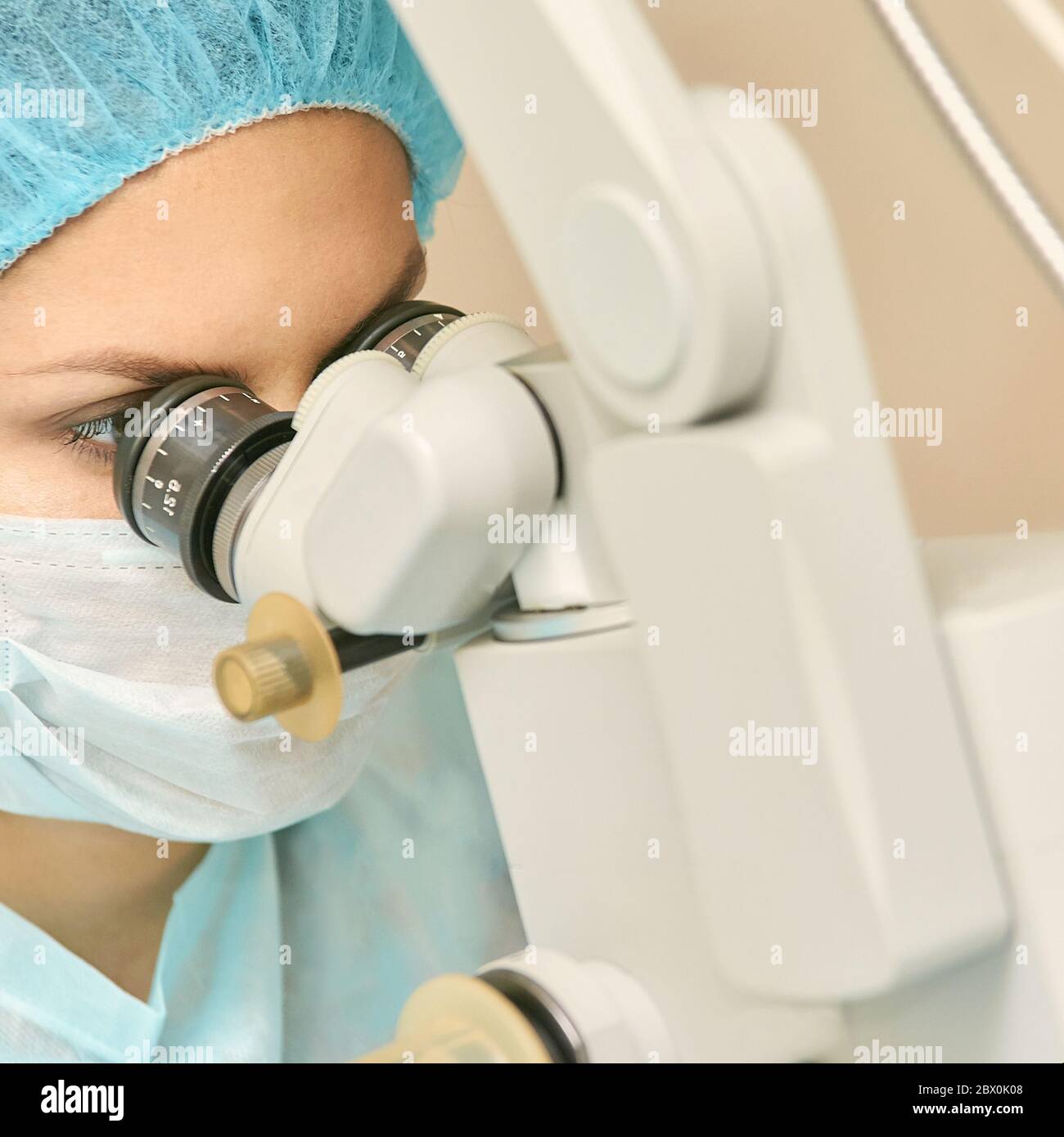 Pretty doctor woman portrait. Ophthalmology laser microscope operation ...