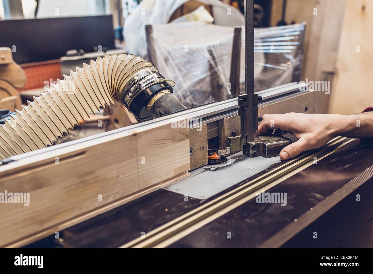 Carpenter workshop - master adjusts milling machine Stock Photo - Alamy