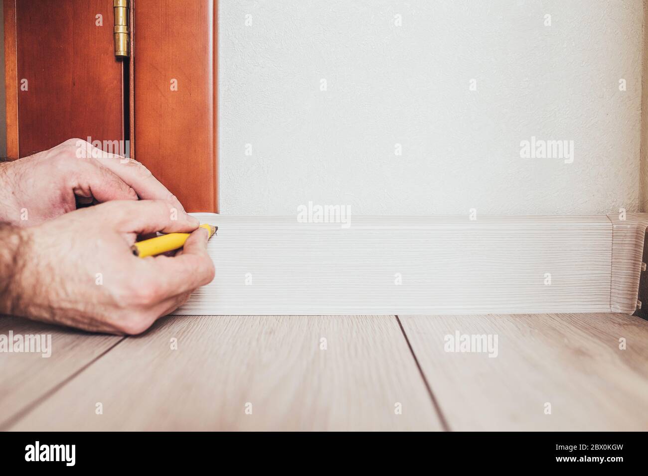 The master mounts the plastic floor plinth - finish - flooring Stock ...
