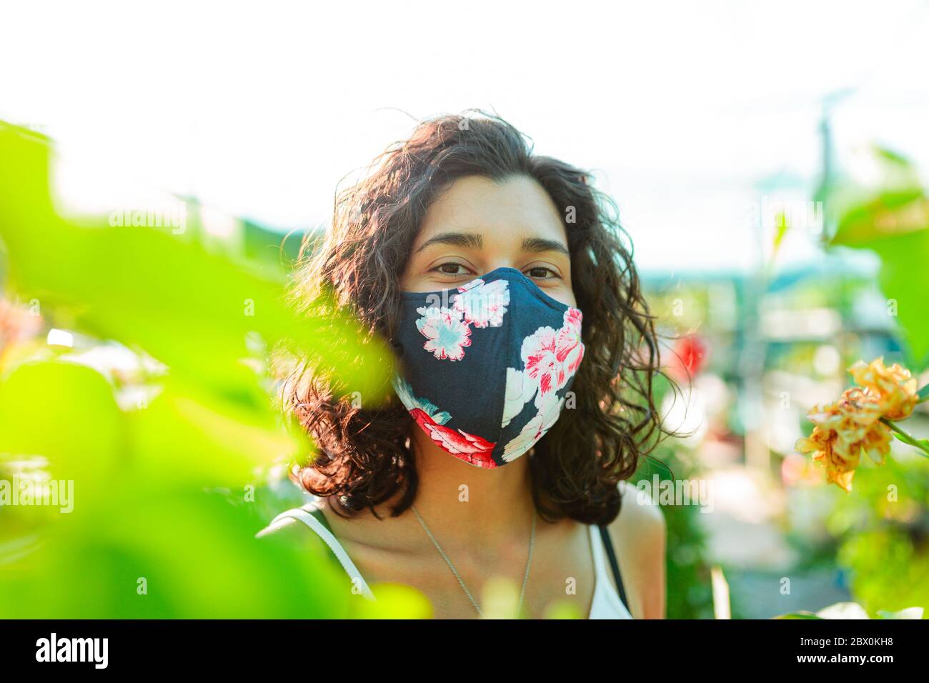 Woman with face mask gardening in greenhouse covid-19 Stock Photo - Alamy
