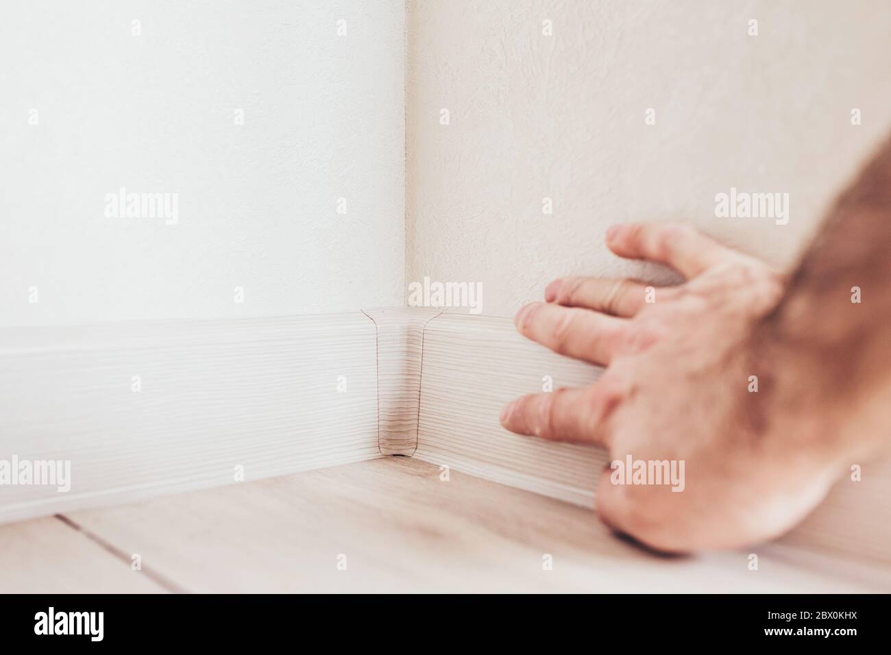 The master mounts the plastic floor plinth - finish - flooring Stock ...