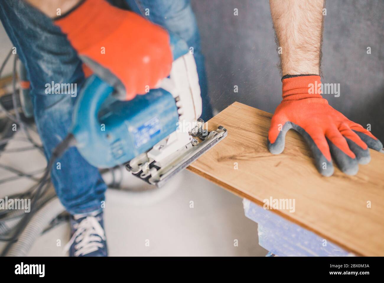 Cutting the laminate with an electric jigsaw - carpentry work during ...