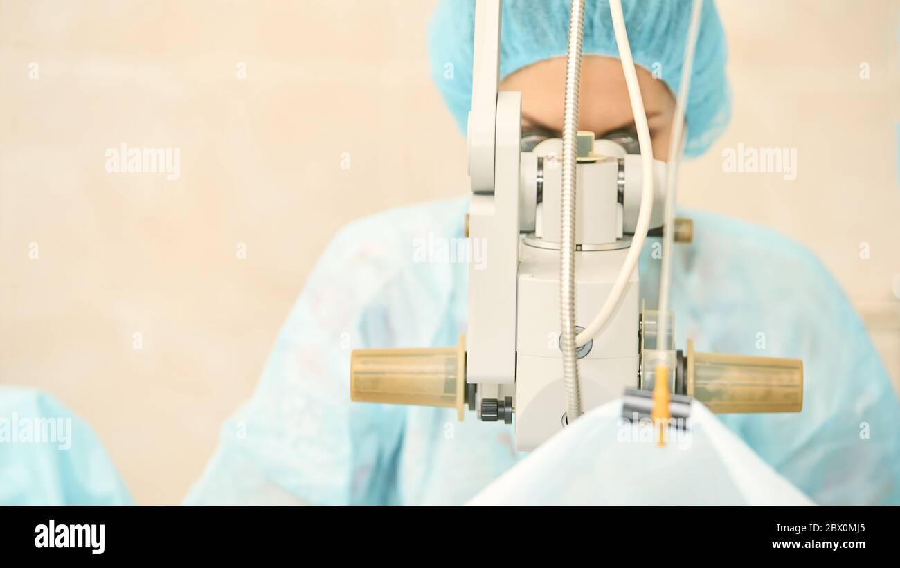 Pretty doctor woman portrait. Ophthalmology laser microscope operation ...