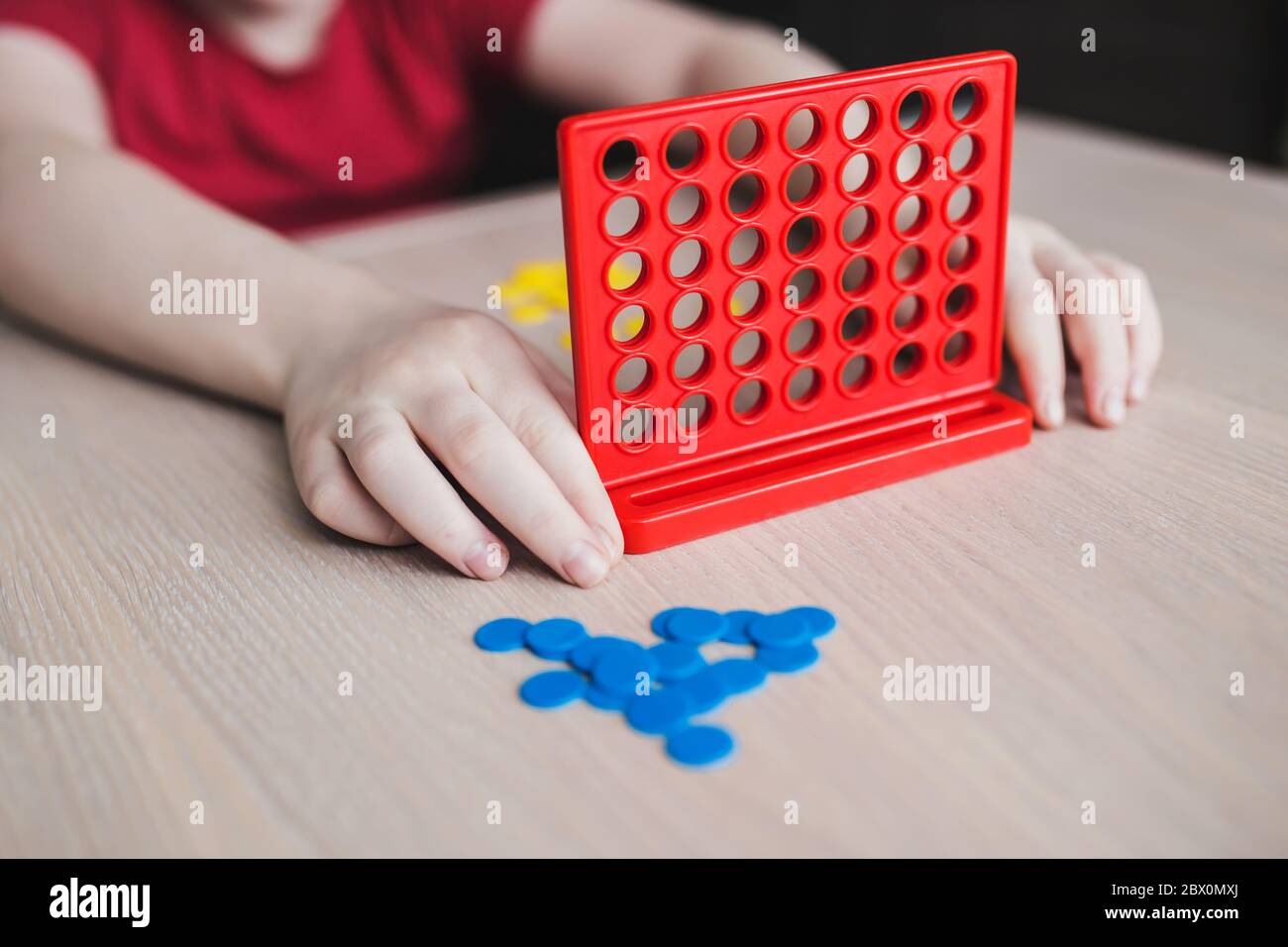The boy wondered playing a board game four in line - home leisure Stock ...