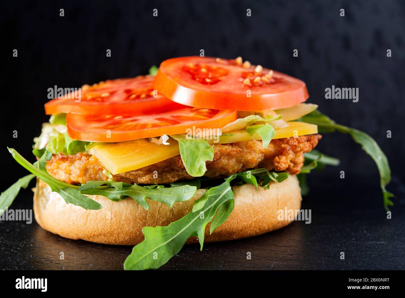 Open cheeseburger with arugula on a dark slate background Stock Photo ...