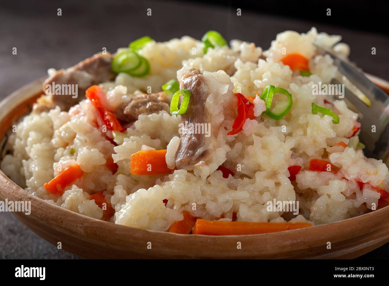 Rice stew with chicken meat and vegetables in bowl Stock Photo - Alamy