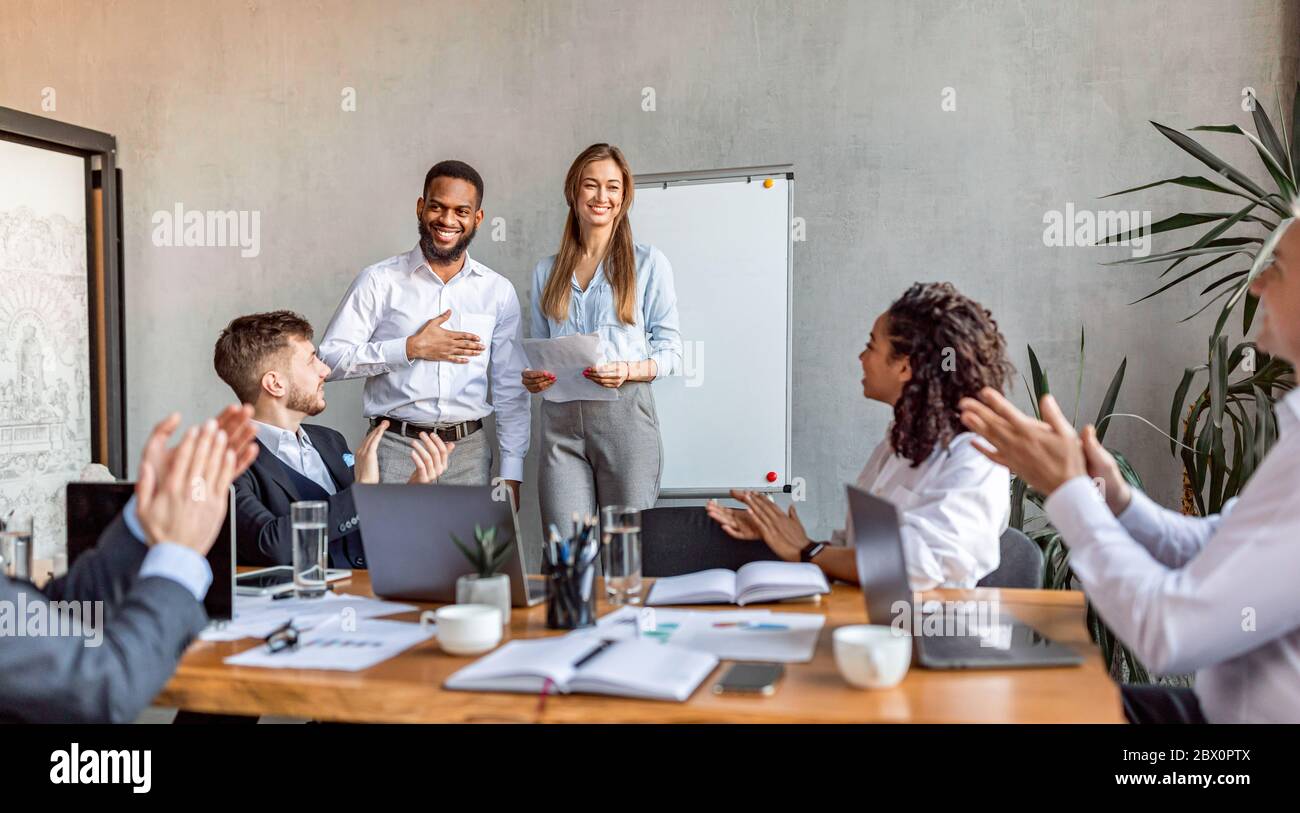 Businesswoman Introducing New Employee To Coworkers Standing In Office ...