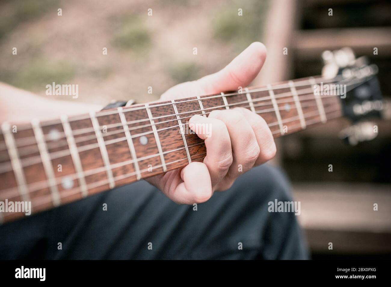 Technique of playing the electric guitar - a man playing outdoors ...