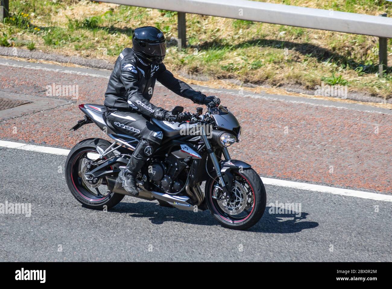 Triumph Street Triple Motorbike rider; two wheeled transport ...