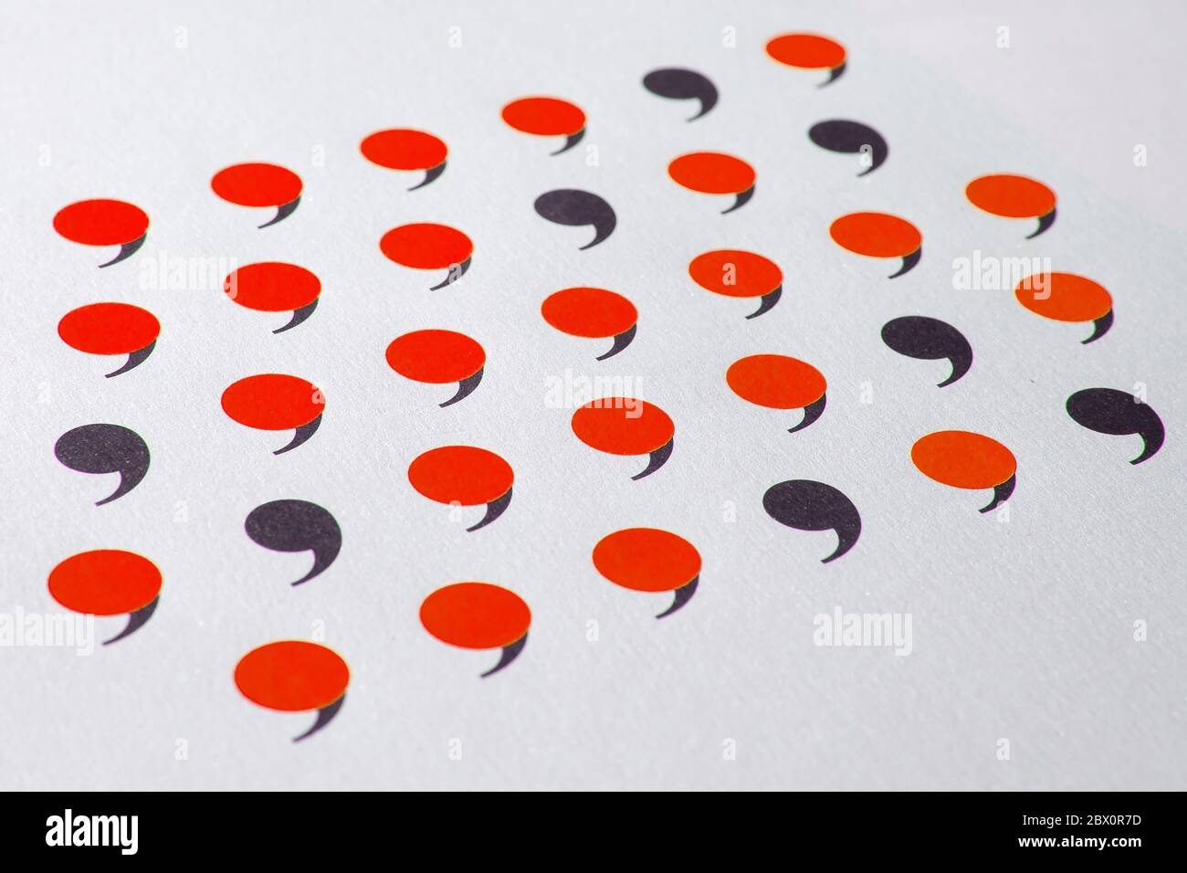 black comma in many red commas Stock Photo - Alamy
