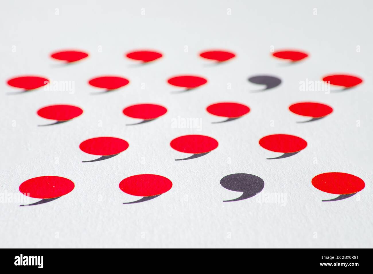 black comma in many red commas Stock Photo - Alamy