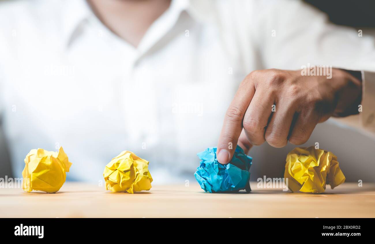 Idea and creativity concepts with person choosing paper crumpled ball ...