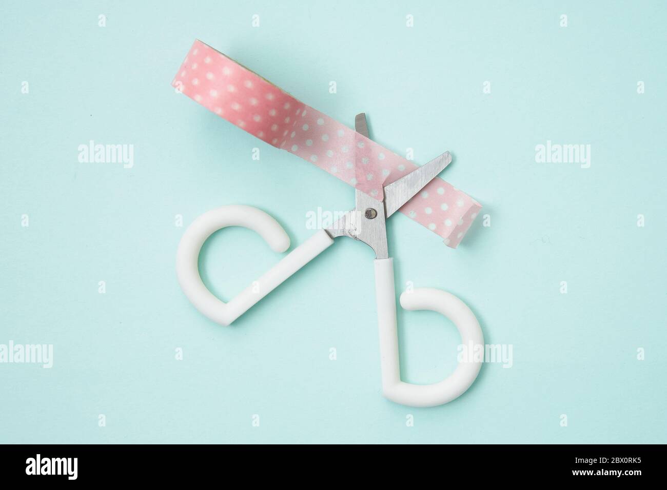 small cute scissors to cut pink paper tape Stock Photo - Alamy
