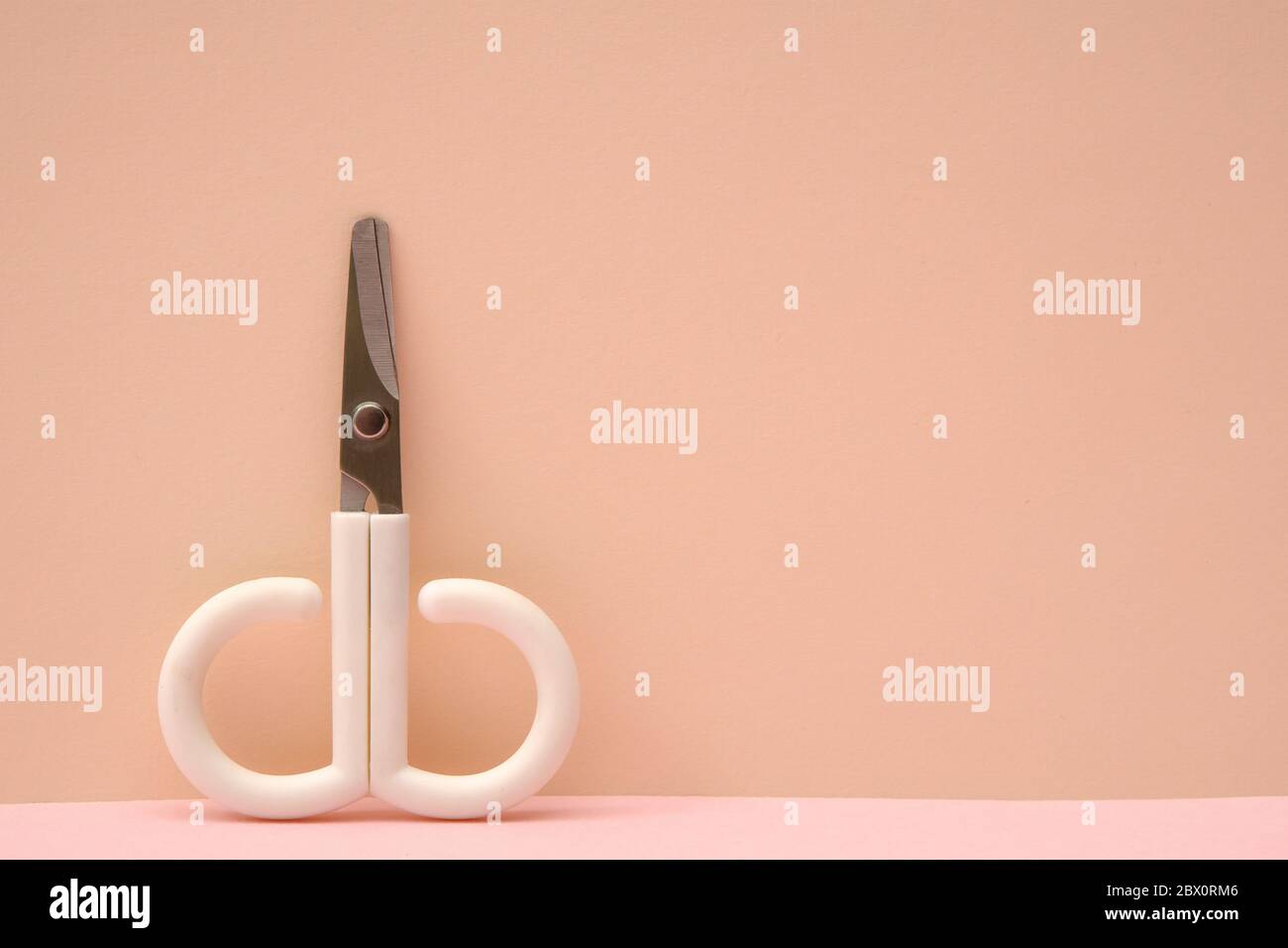 Pink color background and cute little scissors Stock Photo - Alamy