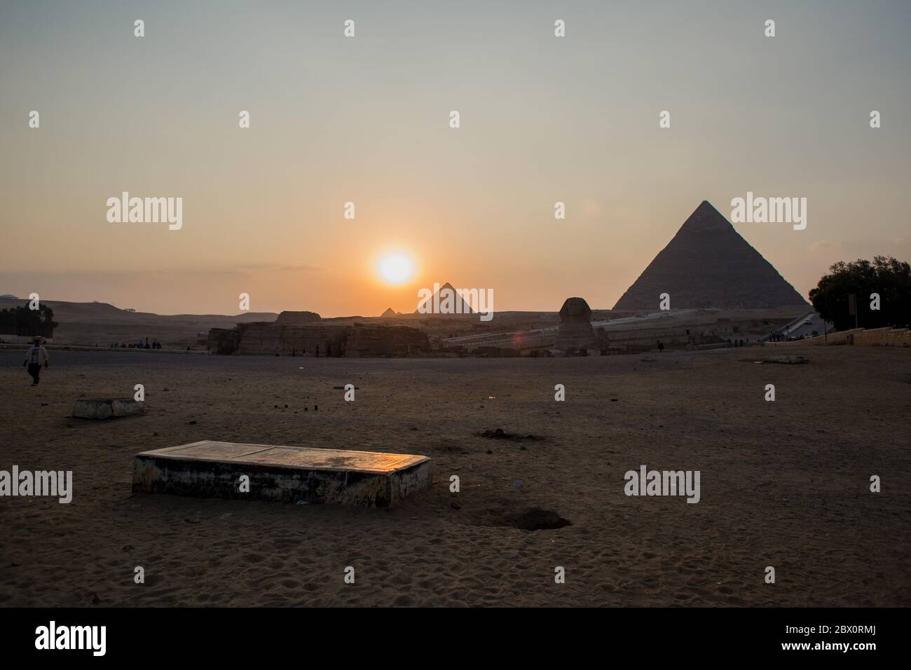 sunset on the background of Egyptian pyramids Stock Photo - Alamy