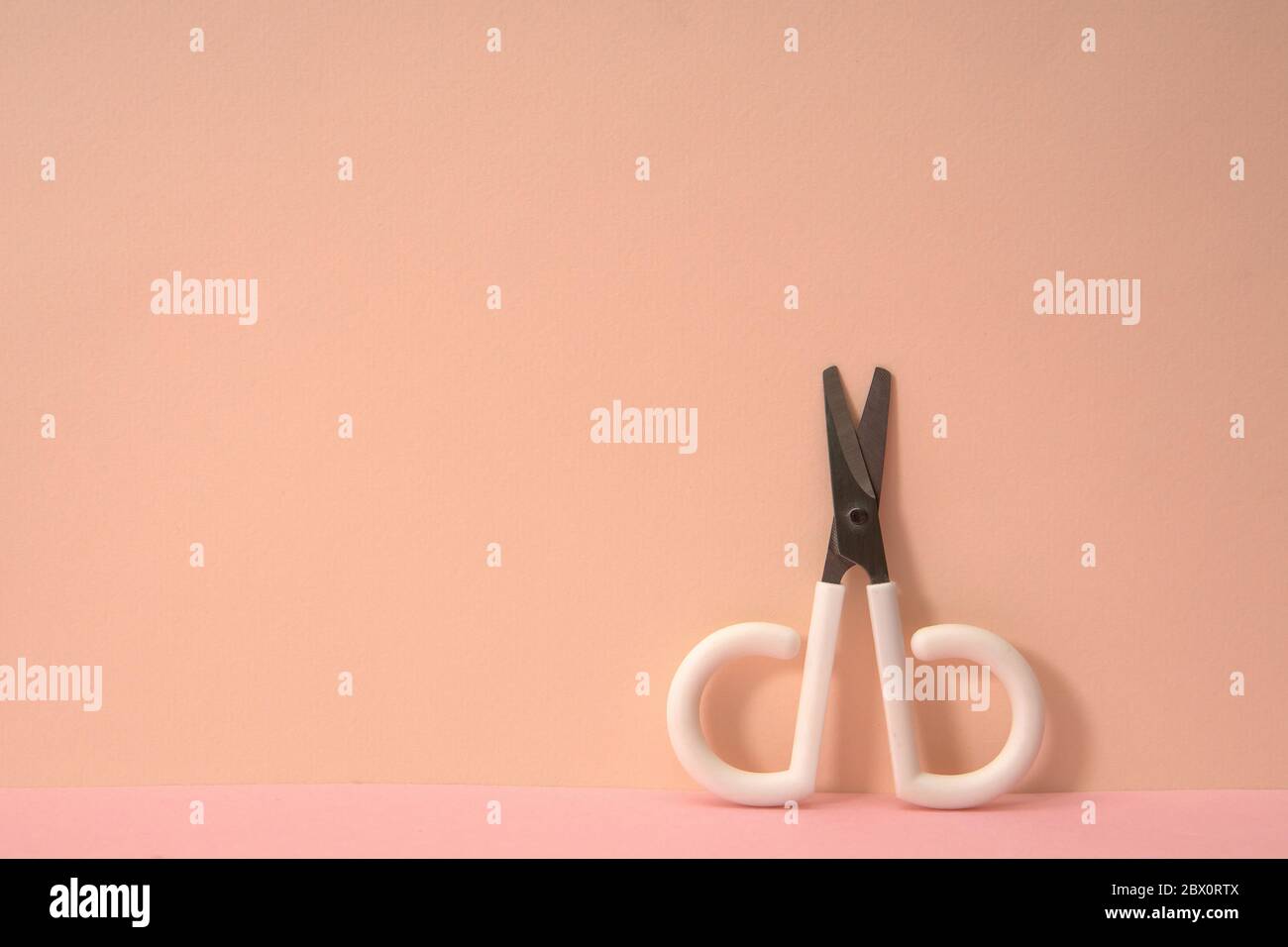 Pink color background and cute little scissors Stock Photo - Alamy