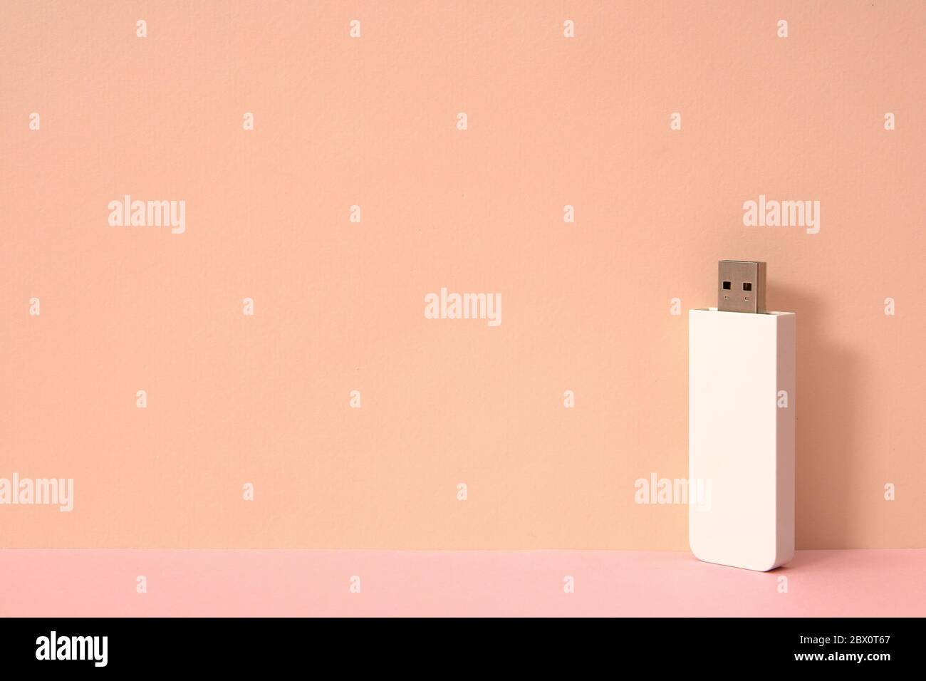 Pink color background and white USB memory storage Stock Photo - Alamy
