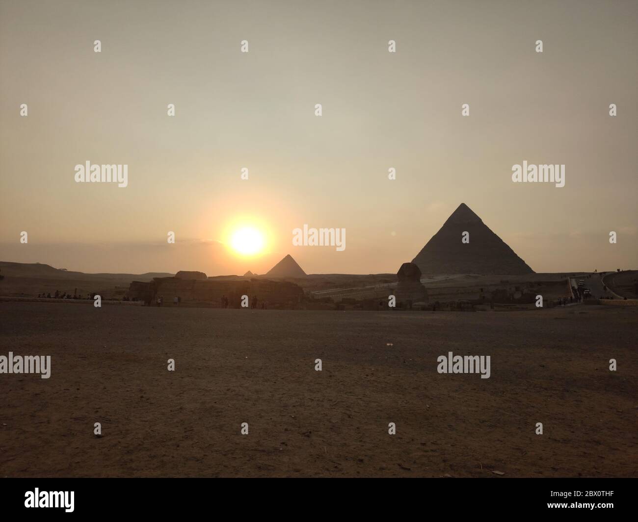 sunset on the background of Egyptian pyramids Stock Photo - Alamy