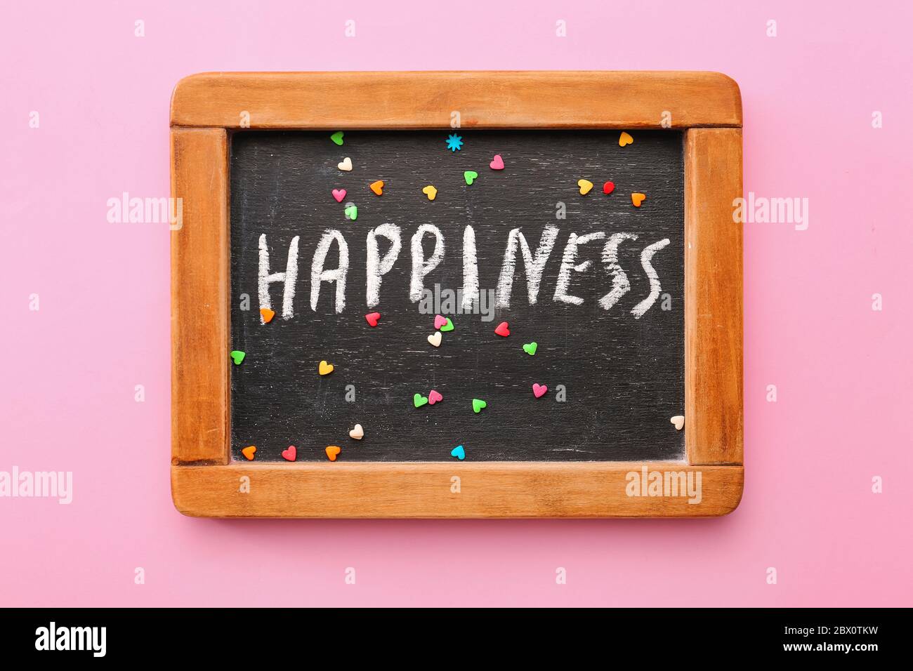 Chalkboard with word HAPPINESS on color background Stock Photo - Alamy