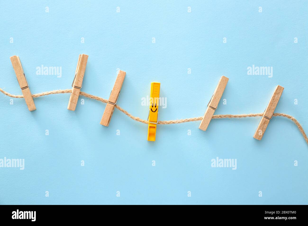 Clothes pegs with drawn smile on color background Stock Photo - Alamy