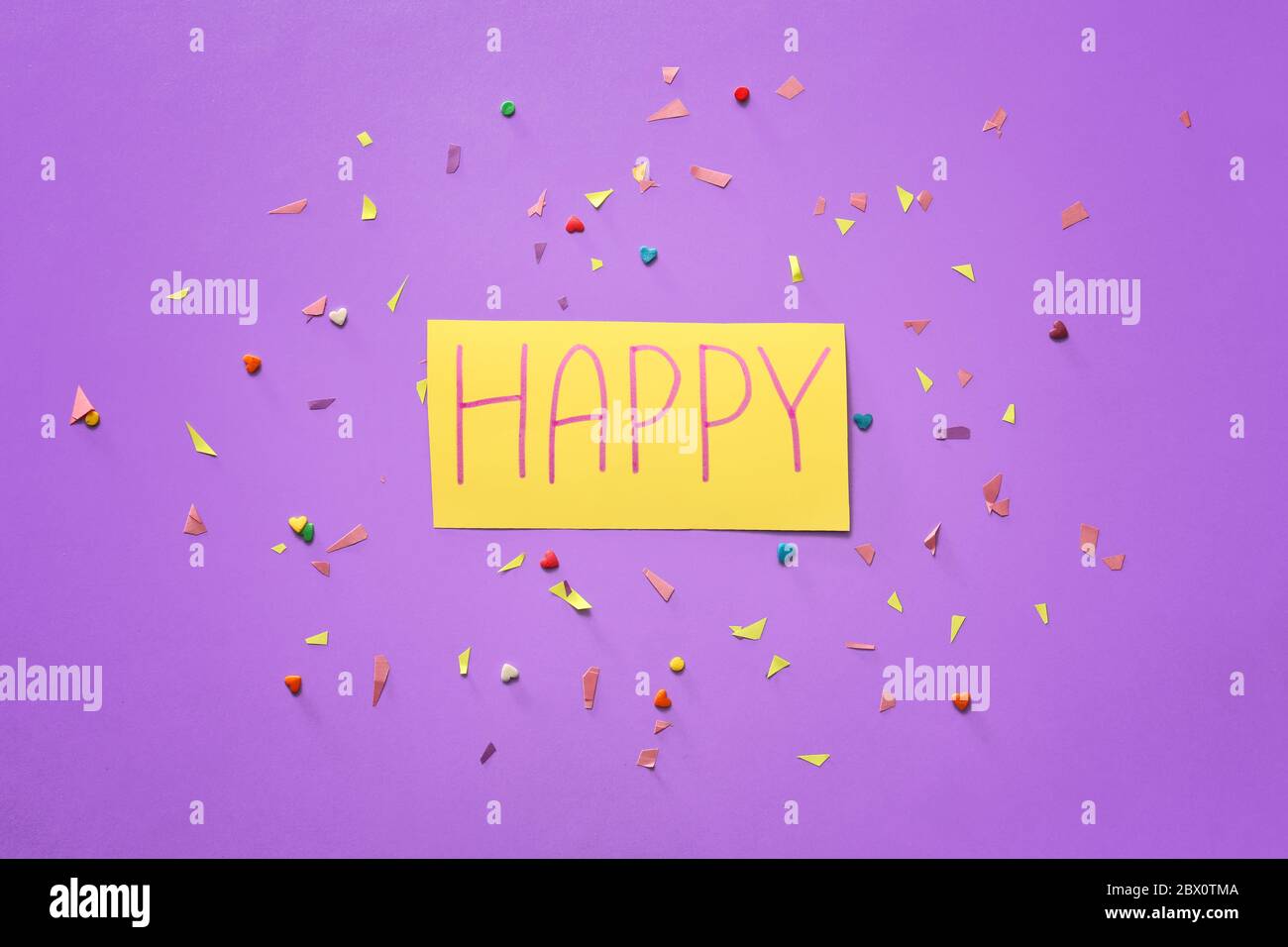 Paper with word HAPPY on color background Stock Photo - Alamy