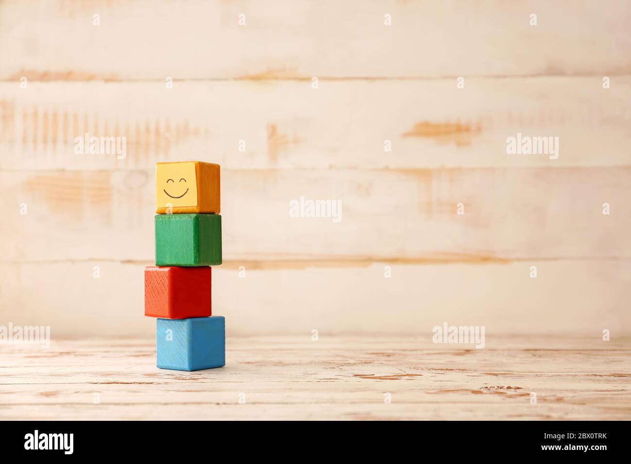 Cubes with drawn smile on white wooden background Stock Photo - Alamy