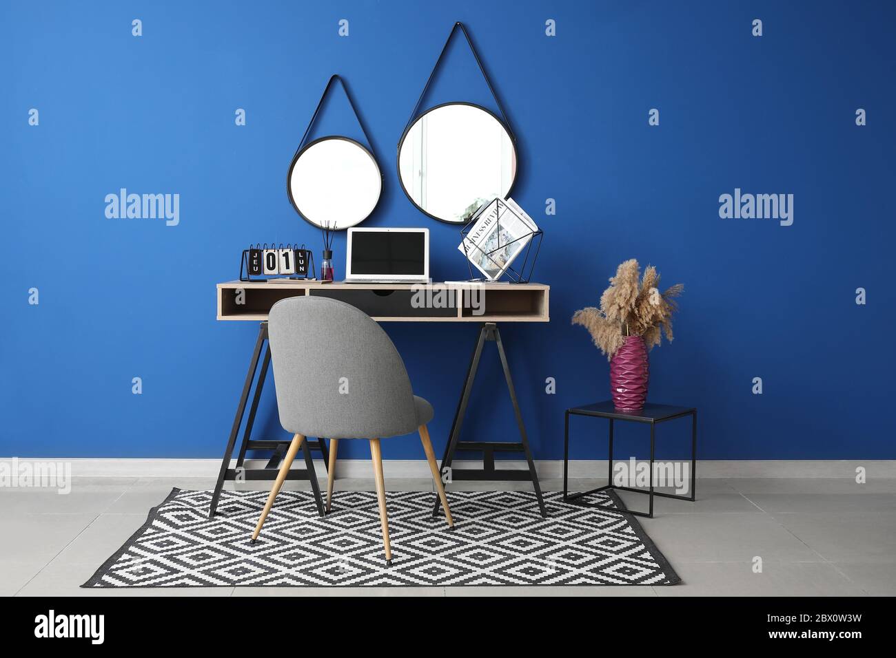 Interior of modern room with workplace and mirrors Stock Photo - Alamy