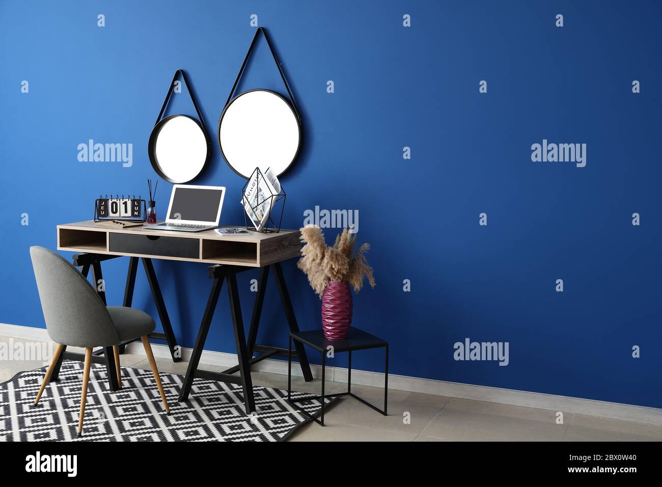 Interior of modern room with workplace and mirrors Stock Photo - Alamy