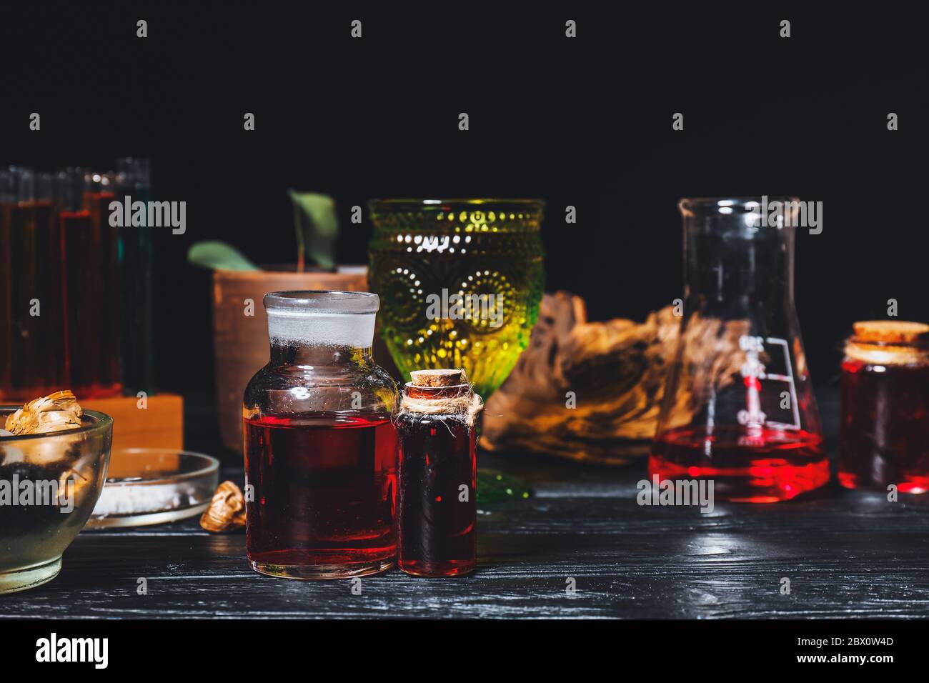 Different potions on alchemist's table Stock Photo - Alamy