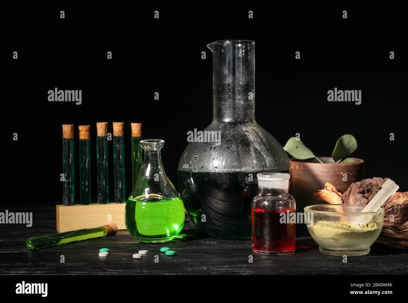 Different potions on alchemist's table Stock Photo - Alamy