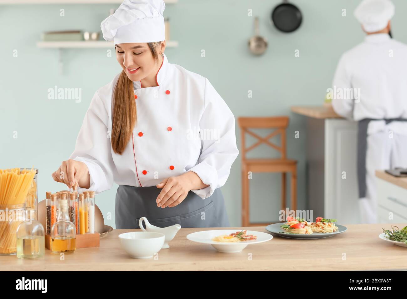 Female chef cooking in kitchen Stock Photo - Alamy