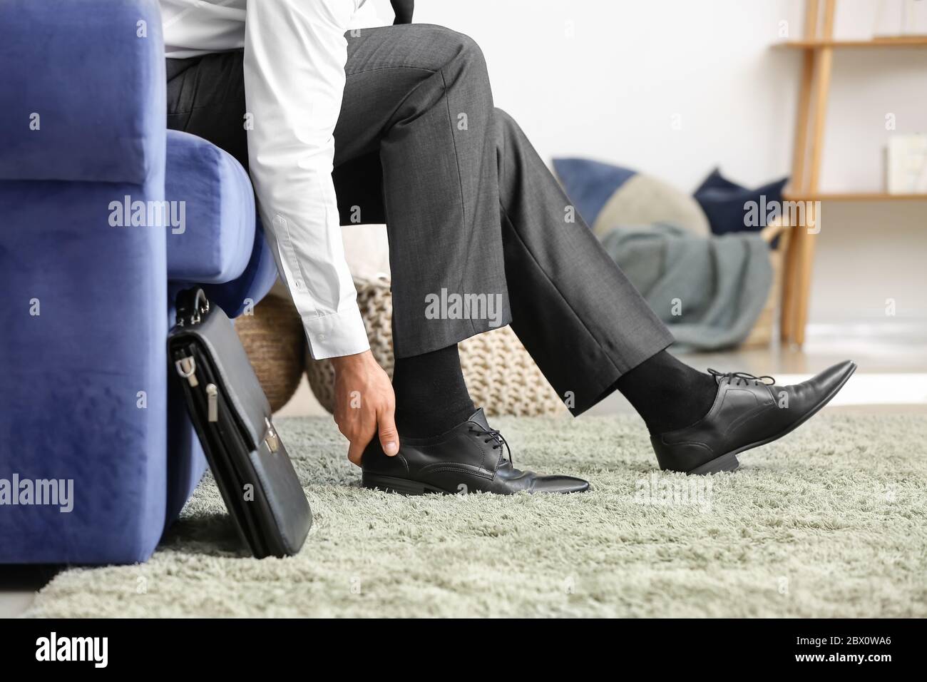Businessman taking off his shoes at home after long working day Stock ...