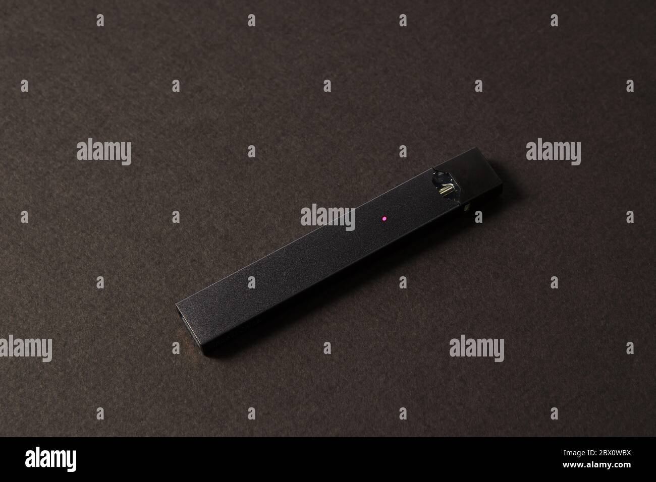black background and electronic cigarette red-lighted juul Stock Photo ...