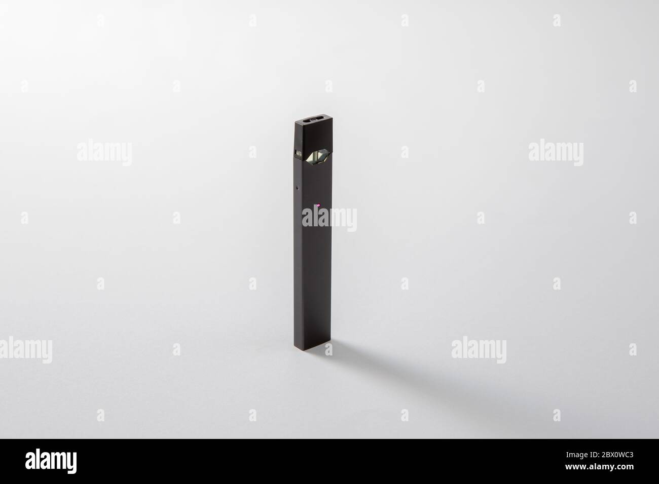 white background and electronic cigarette red-lighted juul Stock Photo ...