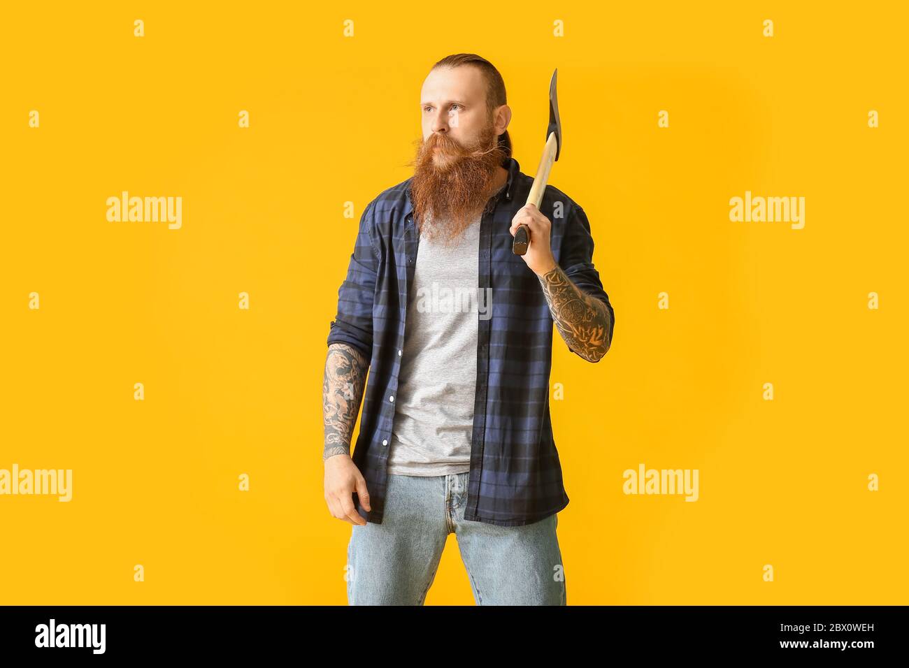 Handsome lumberjack on color background Stock Photo - Alamy
