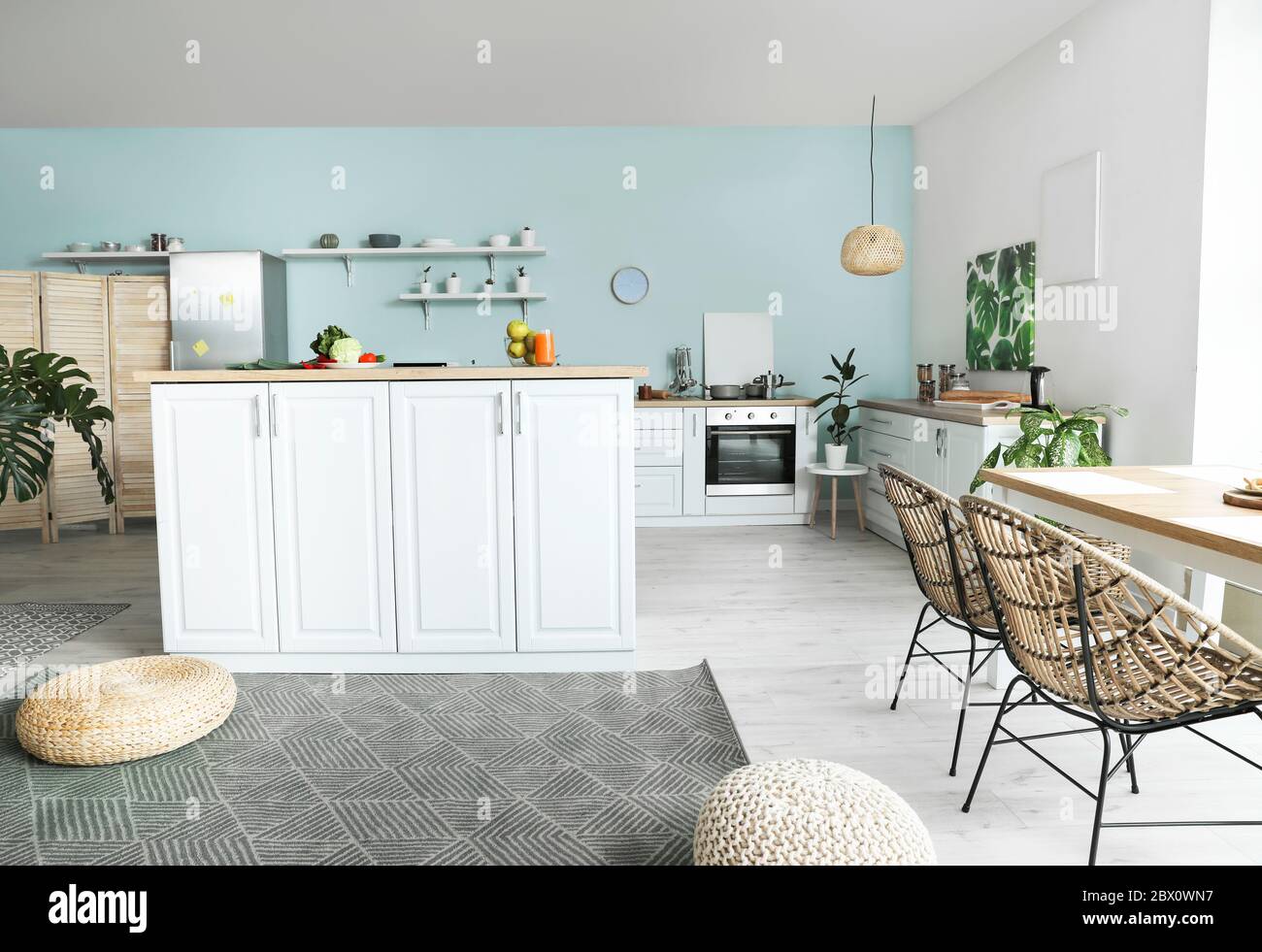 Interior of modern kitchen with stylish table Stock Photo - Alamy